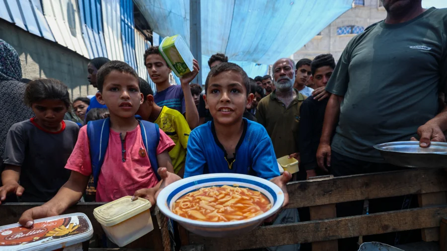 Witnesses Report Shooting at Gaza Aid Distribution Site | NTD